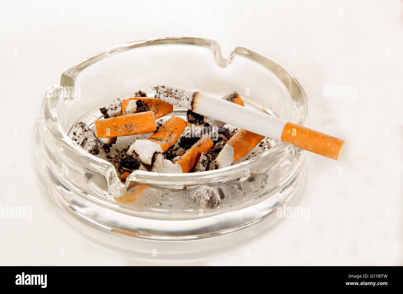 ashtray with cigarette and ash on light background Stock Photo - Alamy
