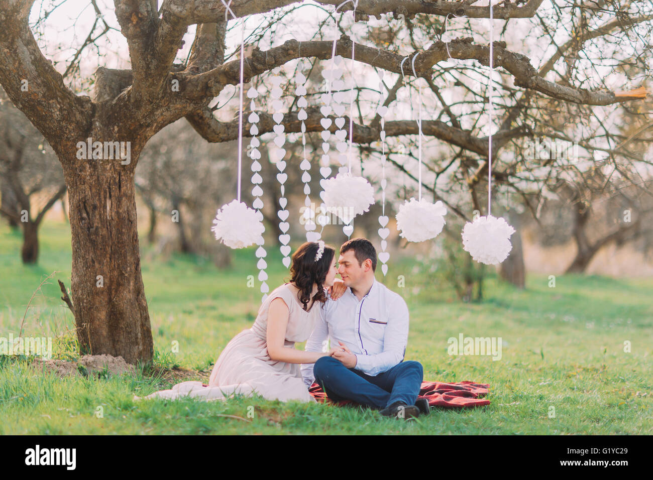 Engagement photo session of beatiful couple in love sitting on plaid ...