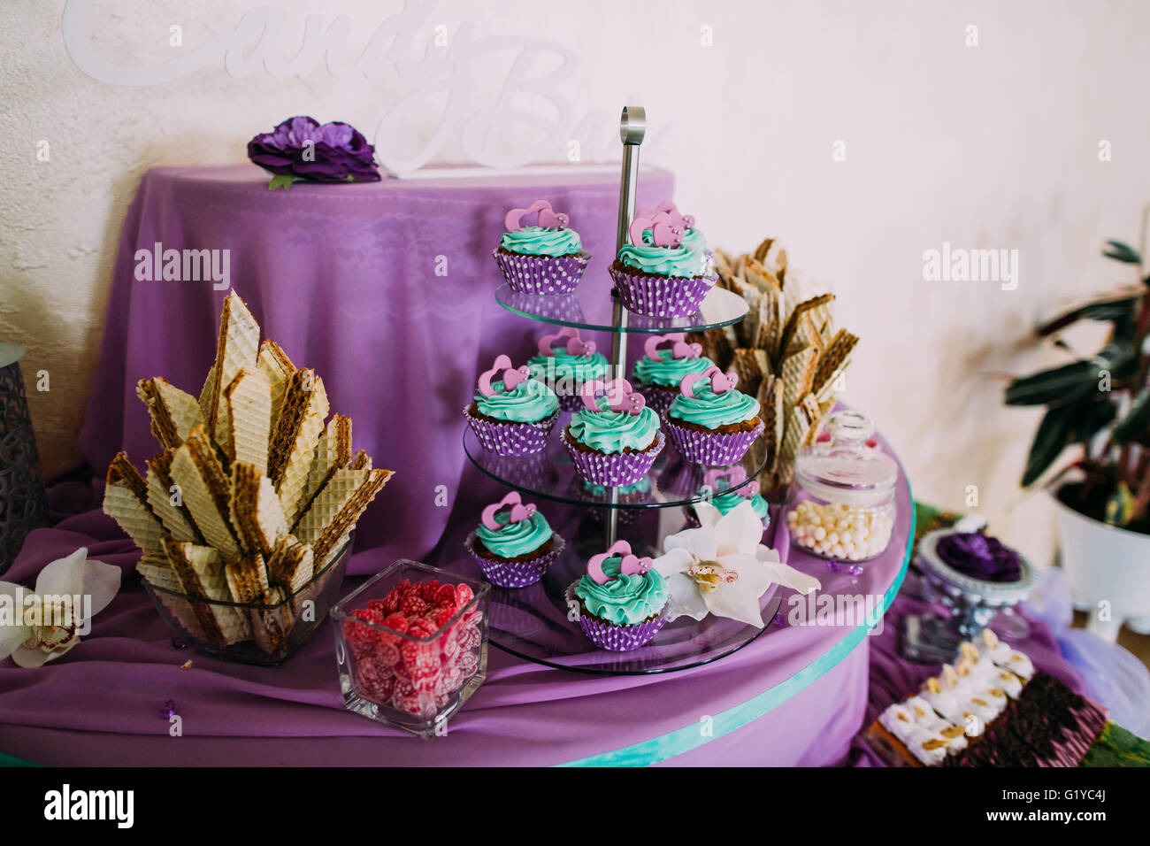 Set of different delicious lavender cakes cupcakes on funny cake-stand ...
