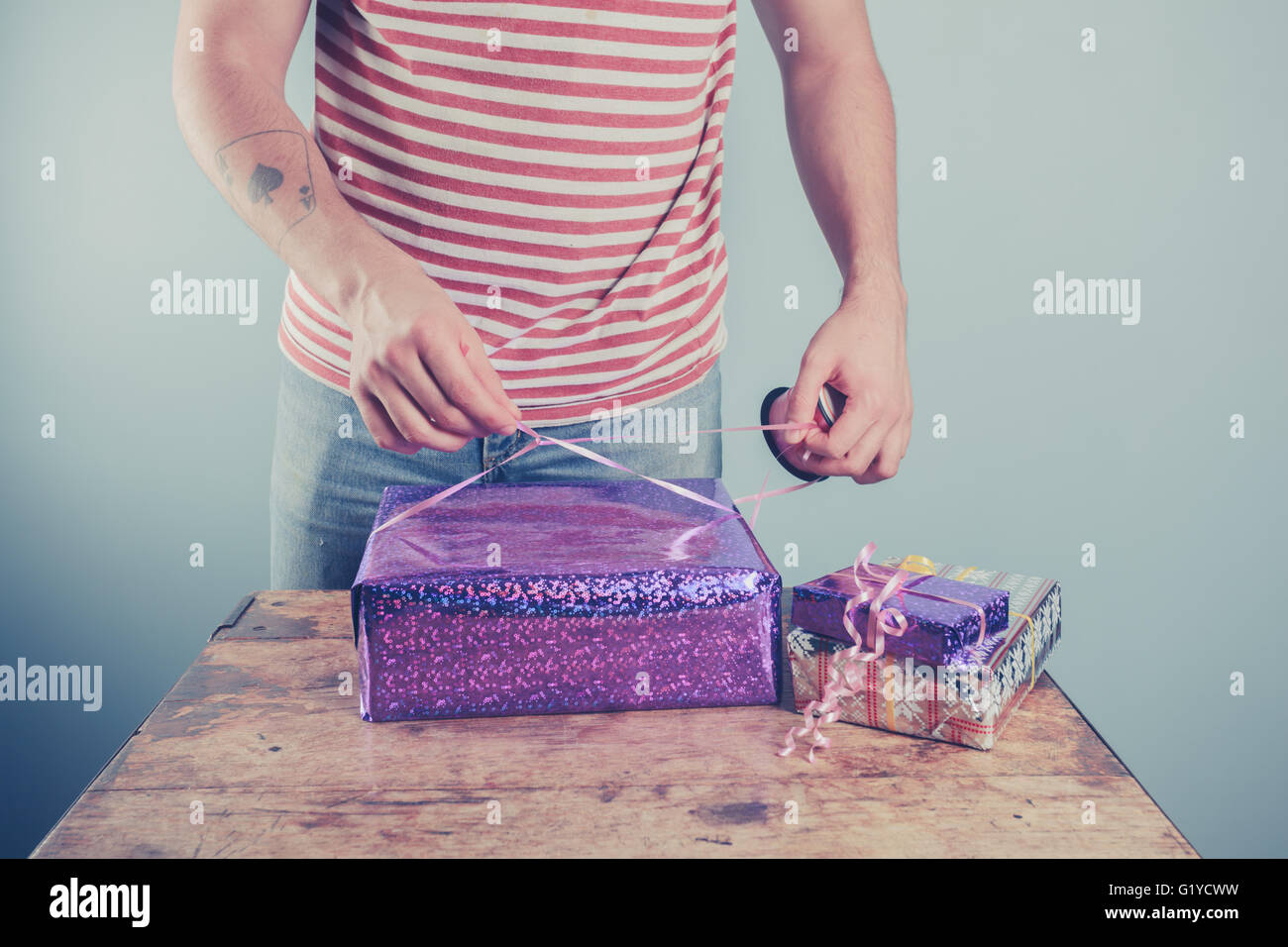 Man wrapping present hi-res stock photography and images - Alamy