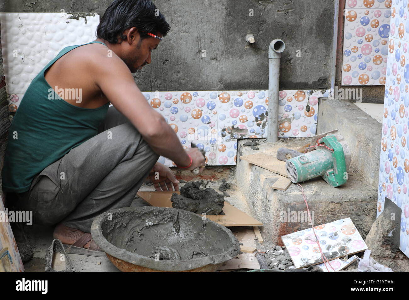 Professional ceramist is laying ceramic tile Stock Photo - Alamy