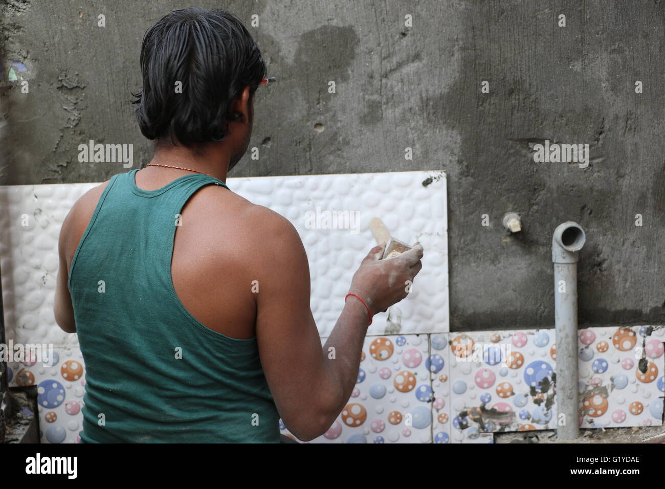 Professional ceramist is laying ceramic tile Stock Photo - Alamy