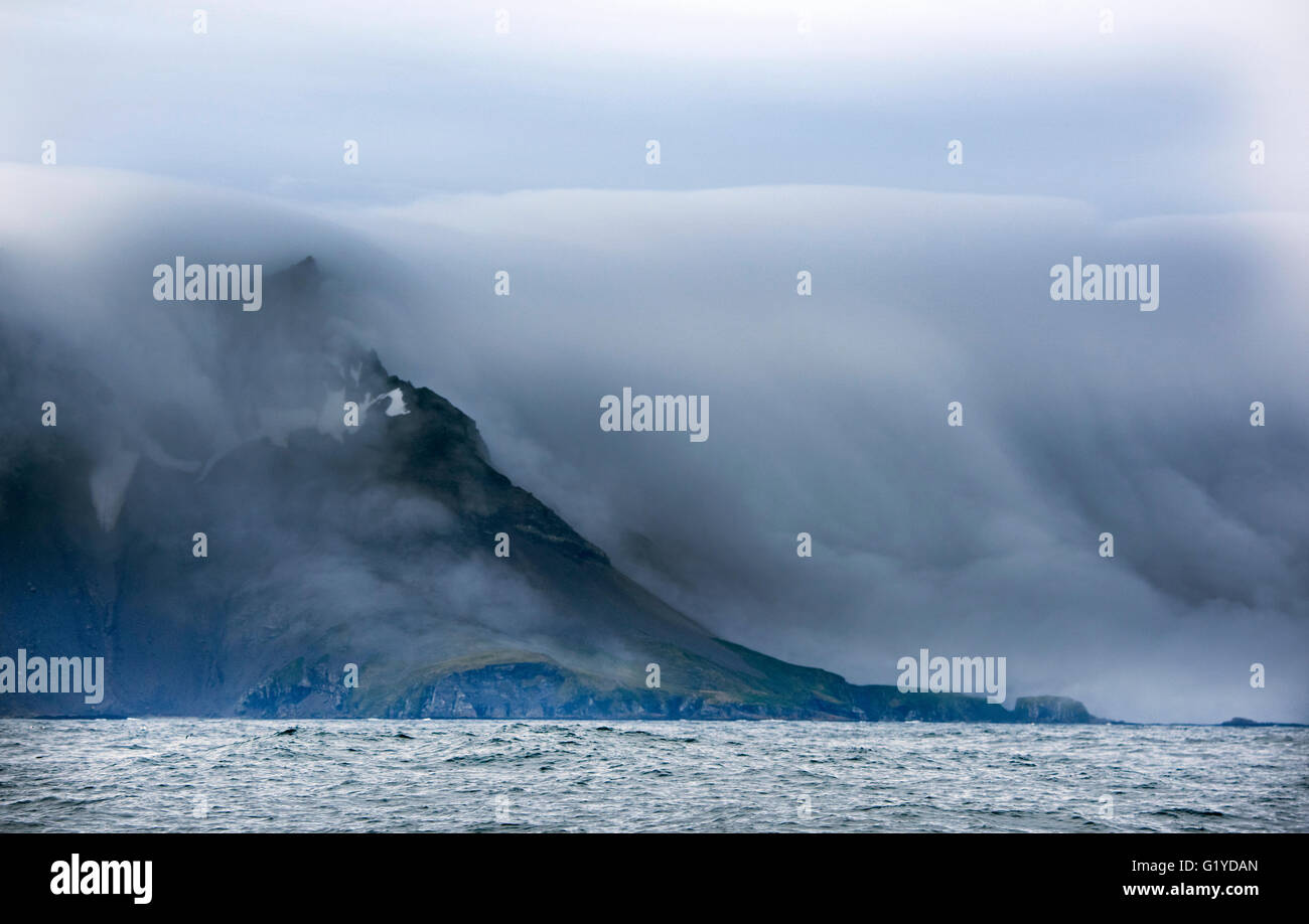 Cloud spilling off Bird Island South Georgia Stock Photo - Alamy