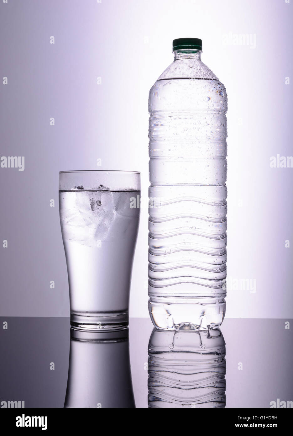 Bottle and Glass water on glass table Stock Photo - Alamy