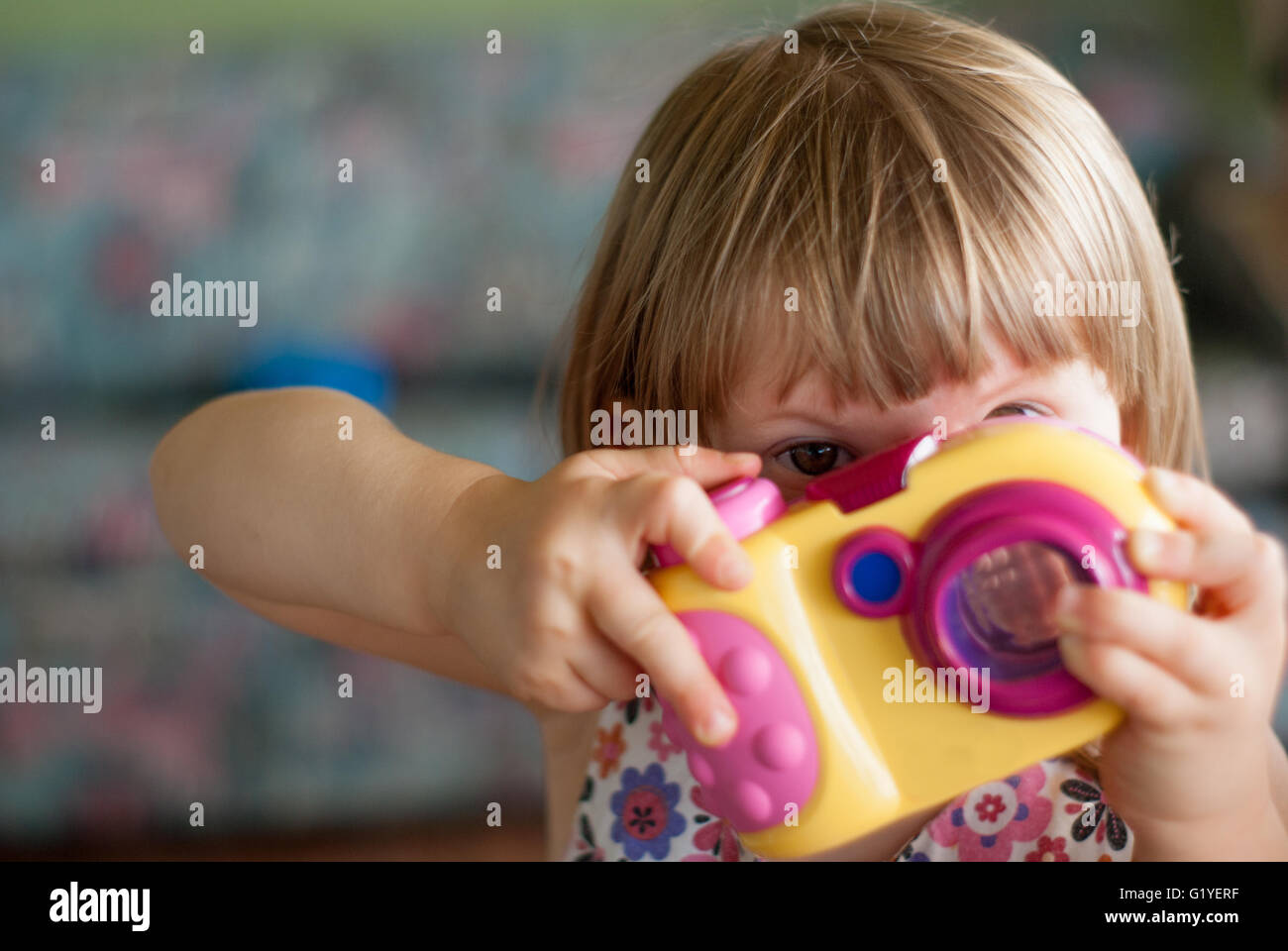Little girl child playing with camera, taking a photo Stock Photo - Alamy