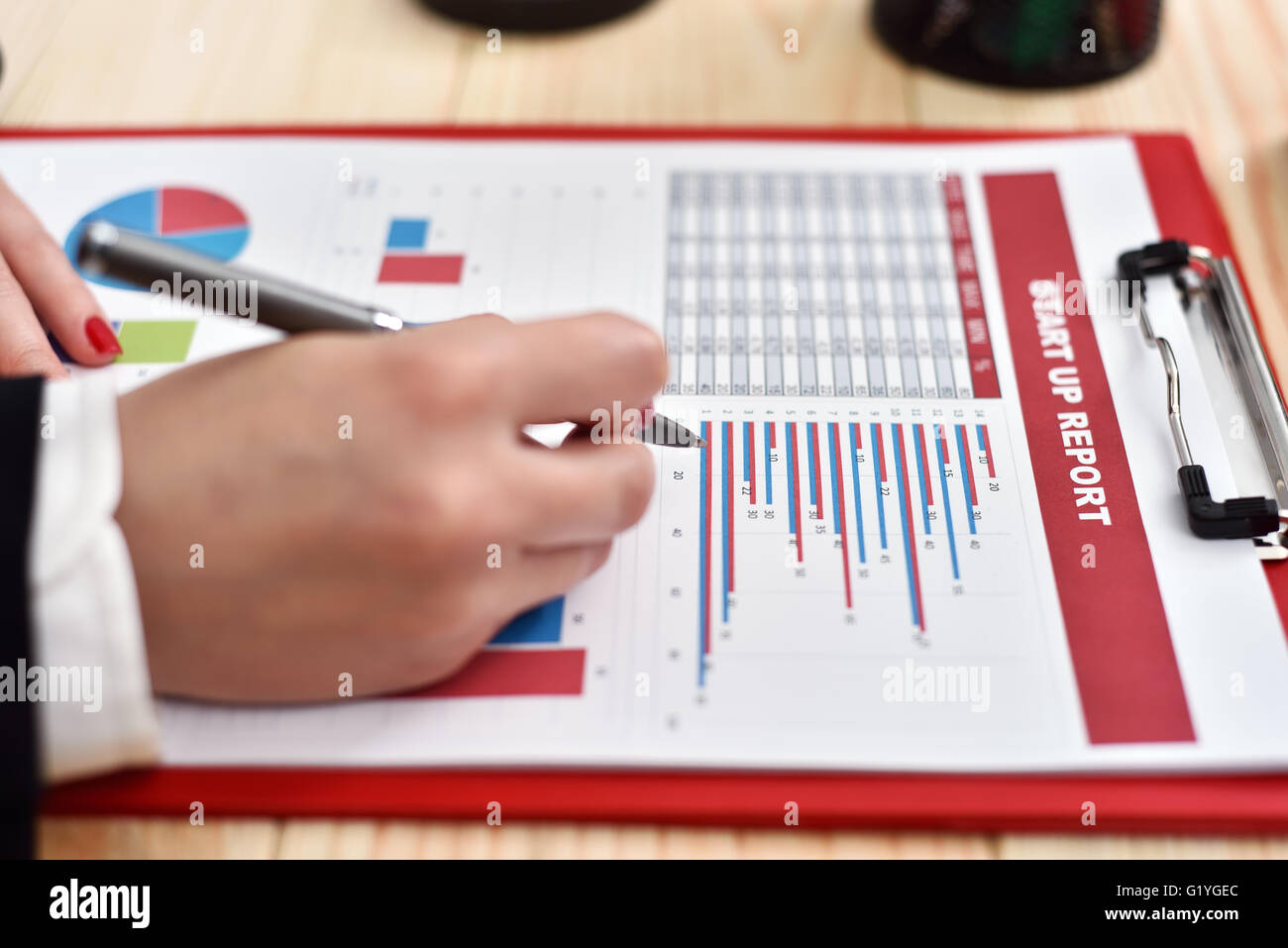 hand checks the start up report. business concept Stock Photo - Alamy
