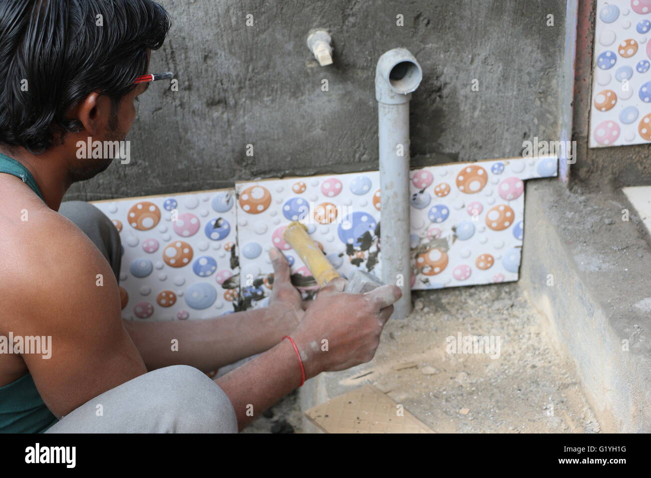 Professional ceramist is laying ceramic tile Stock Photo - Alamy