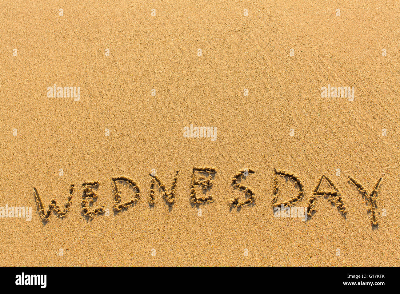 Wednesday - written by hand on a golden beach sand Stock Photo - Alamy