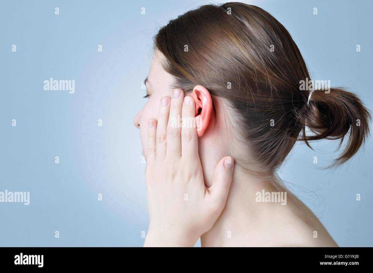 Young woman touching her inflamed ear Stock Photo - Alamy