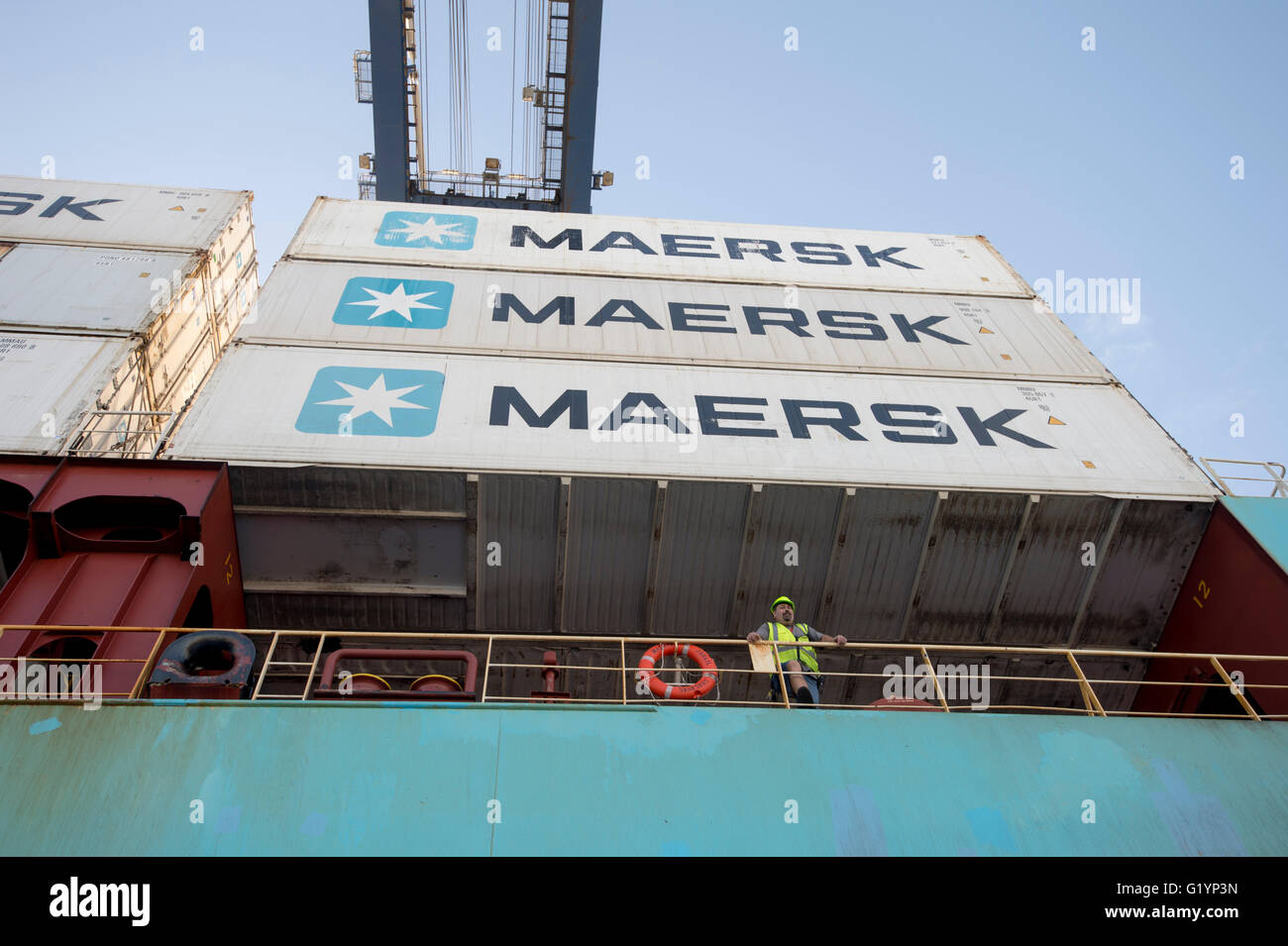 Crew member looking over rail to water below Maersk Container ship ...