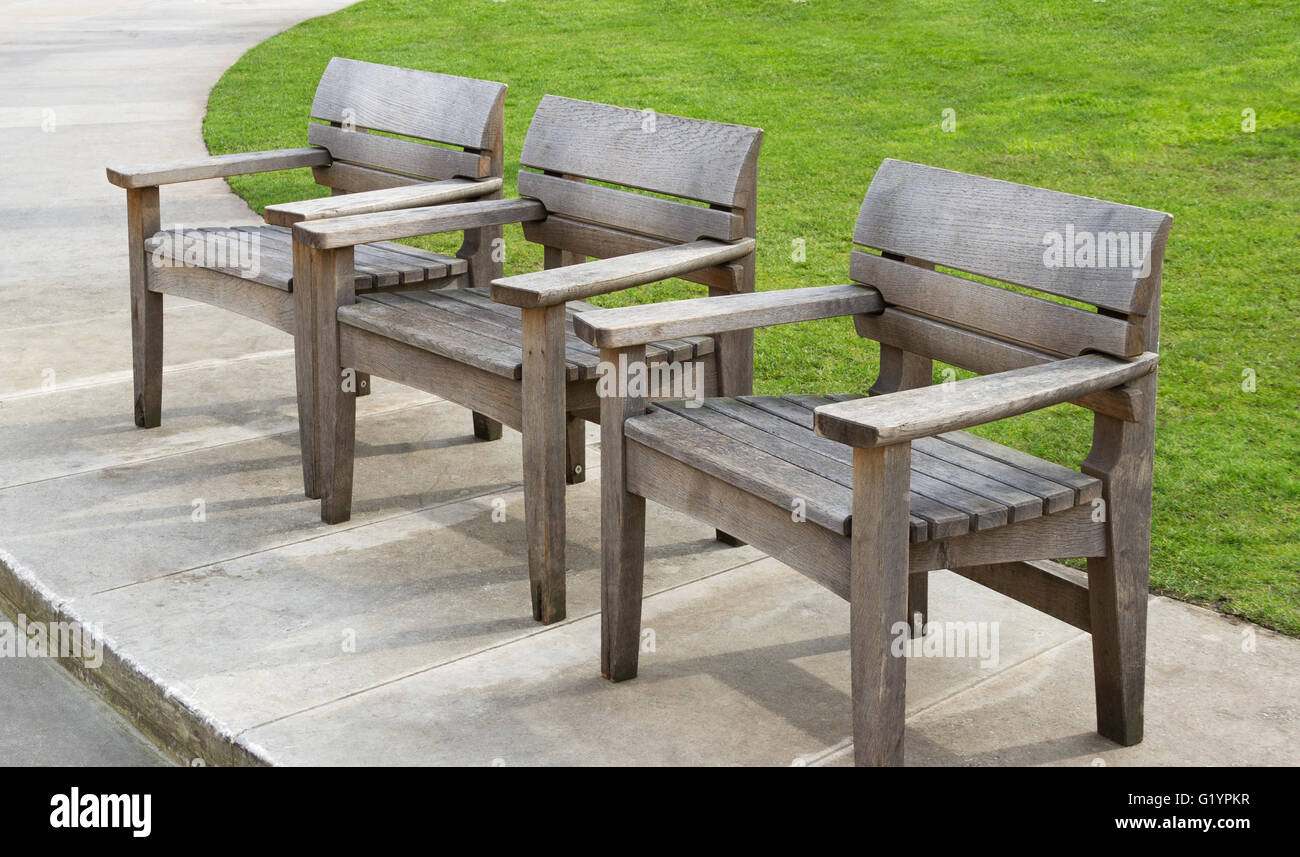 Three wooden benches in London park Stock Photo - Alamy