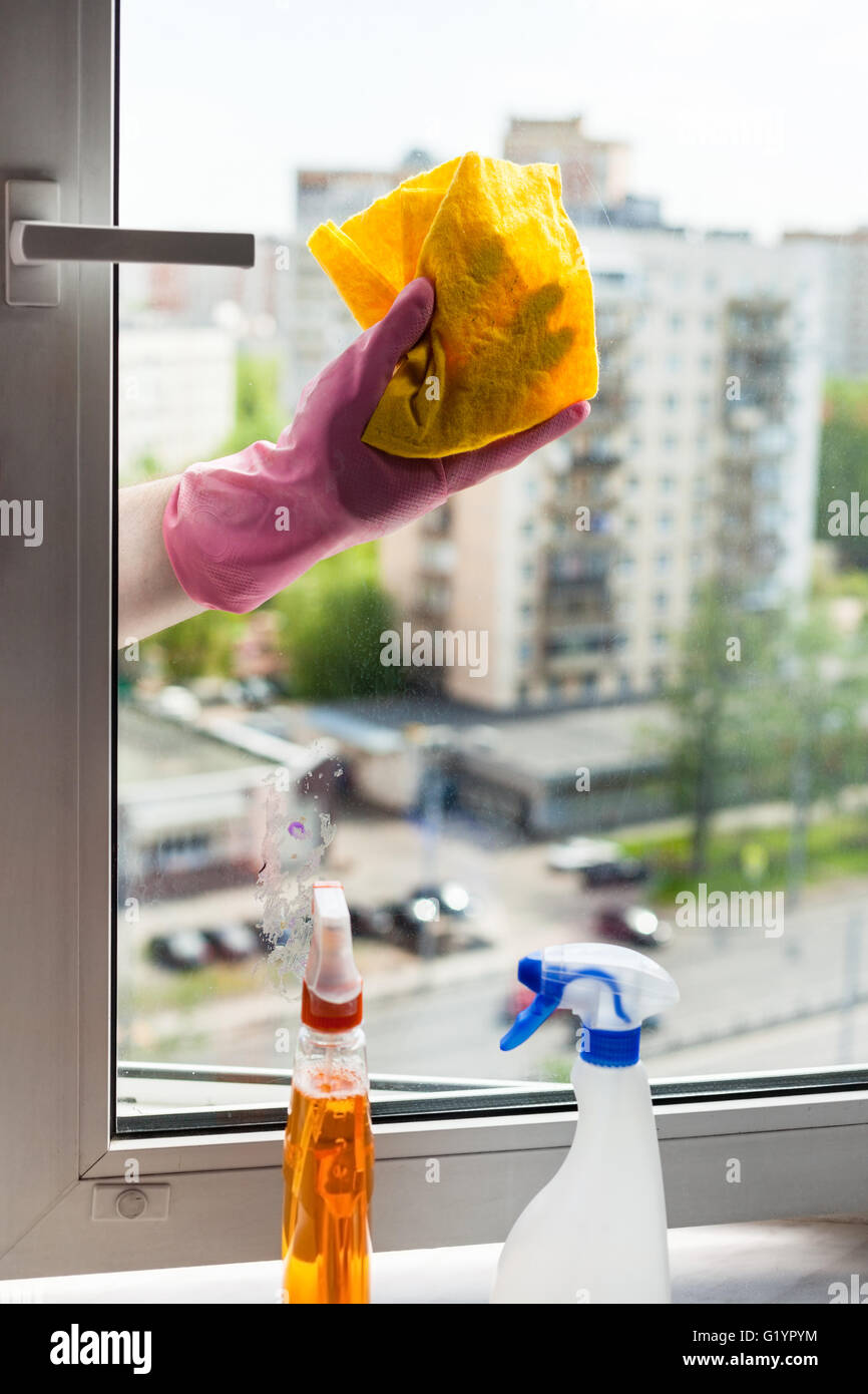 washing home window in spring - washer wipes window frame by rag in ...
