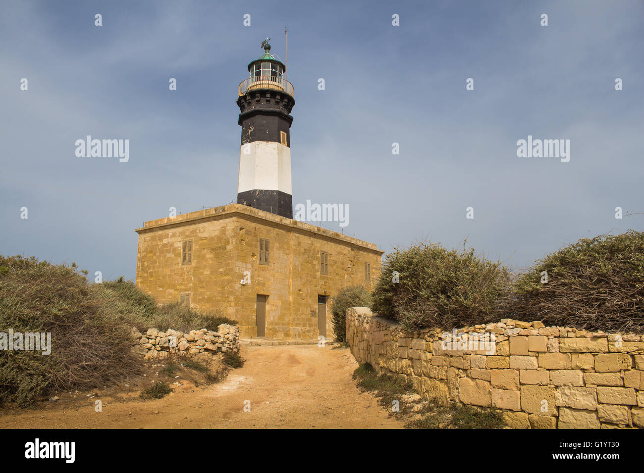 Black and white tower of the lighthouse at the island Malta, Delimara ...