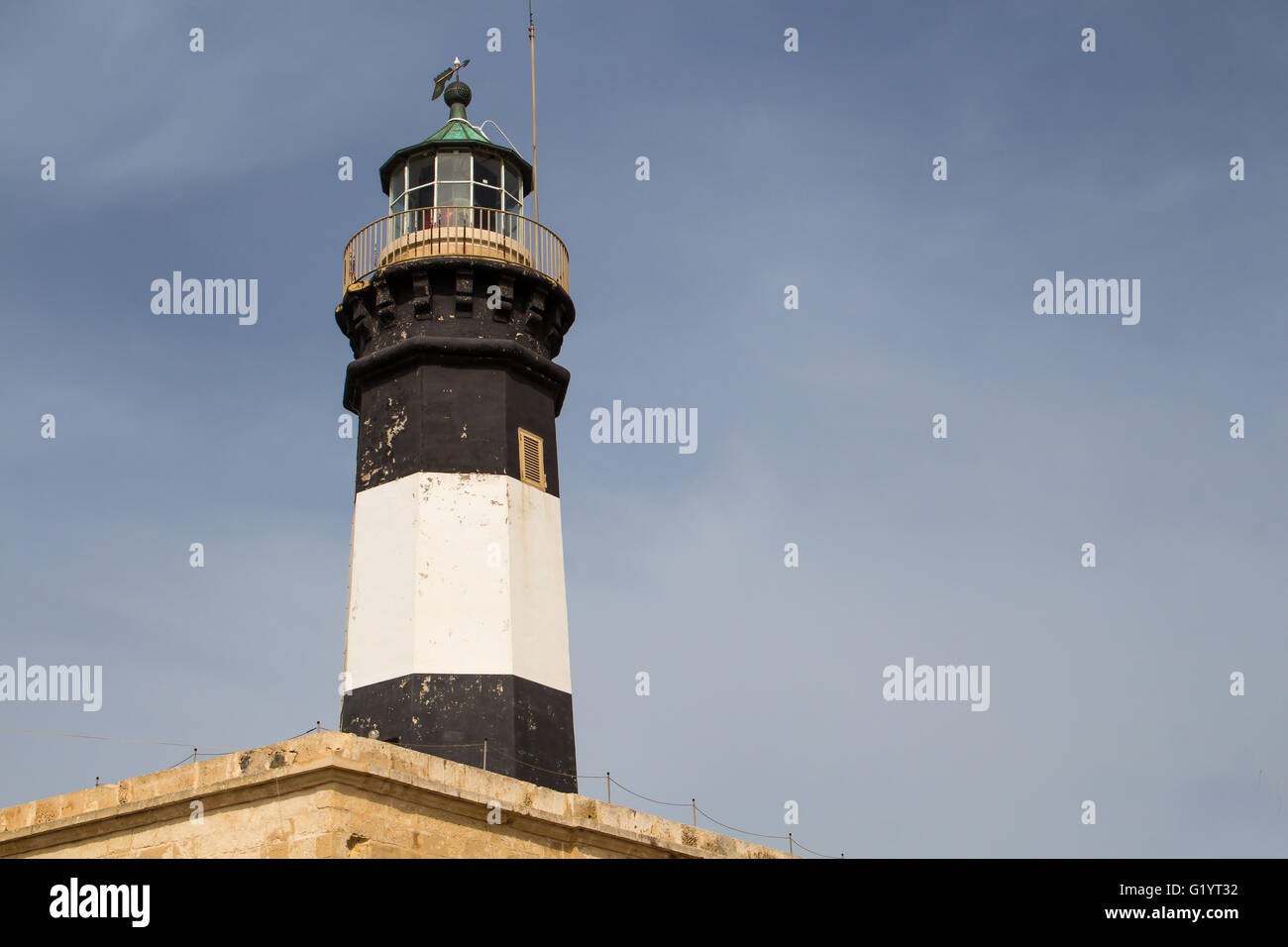 Black and white tower of the lighthouse at the island Malta, Delimara ...