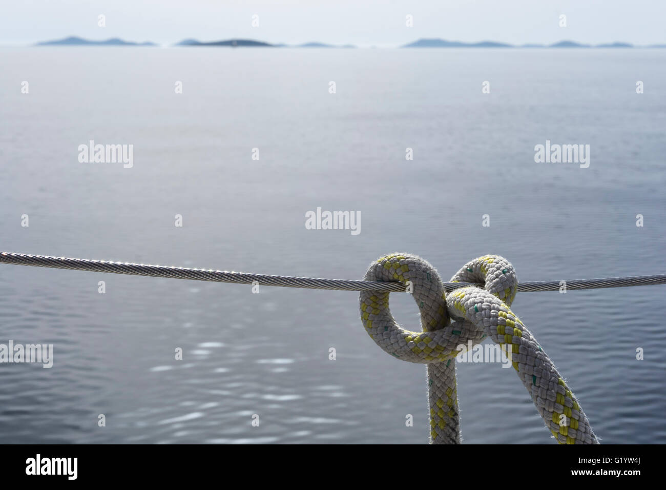 Mooring rope tied around a lifeline with clove hitch Stock Photo - Alamy