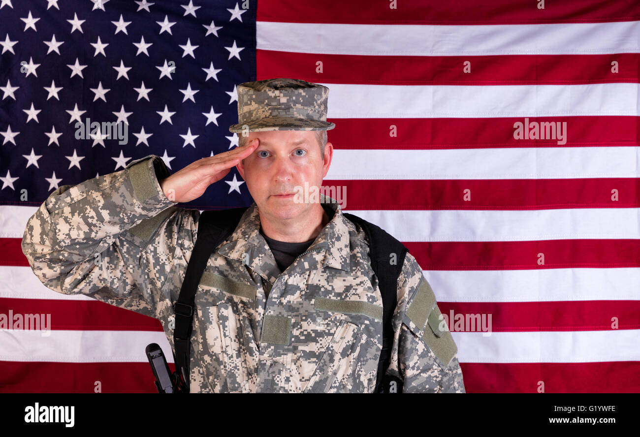 Veteran male soldier, facing forward, saluting with USA flag in ...