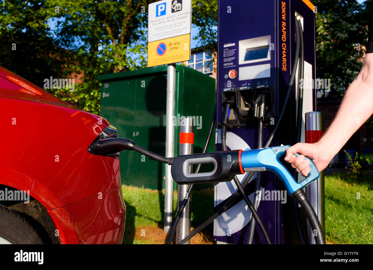 Electric car being charged at public charging point Stock Photo - Alamy