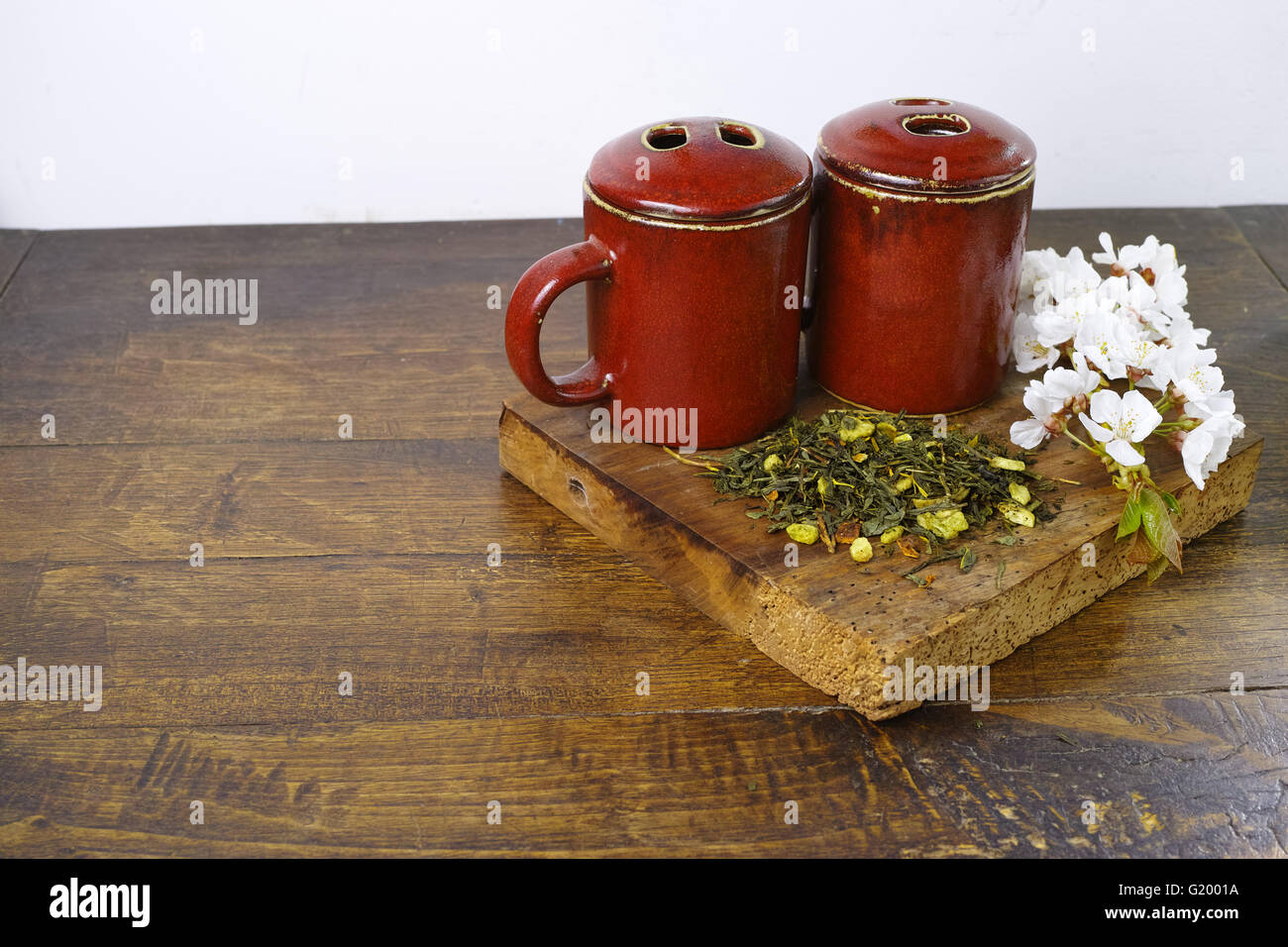 Japan's tea cups with green tea on wooden plank and sakura flowers on ...