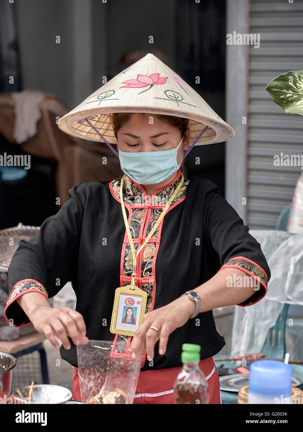 Thailand street food vendor wearing a hygiene face mask whilst ...