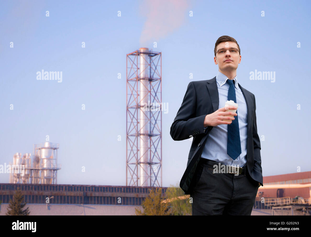 Handsome young businessman on the industrial building background Stock ...