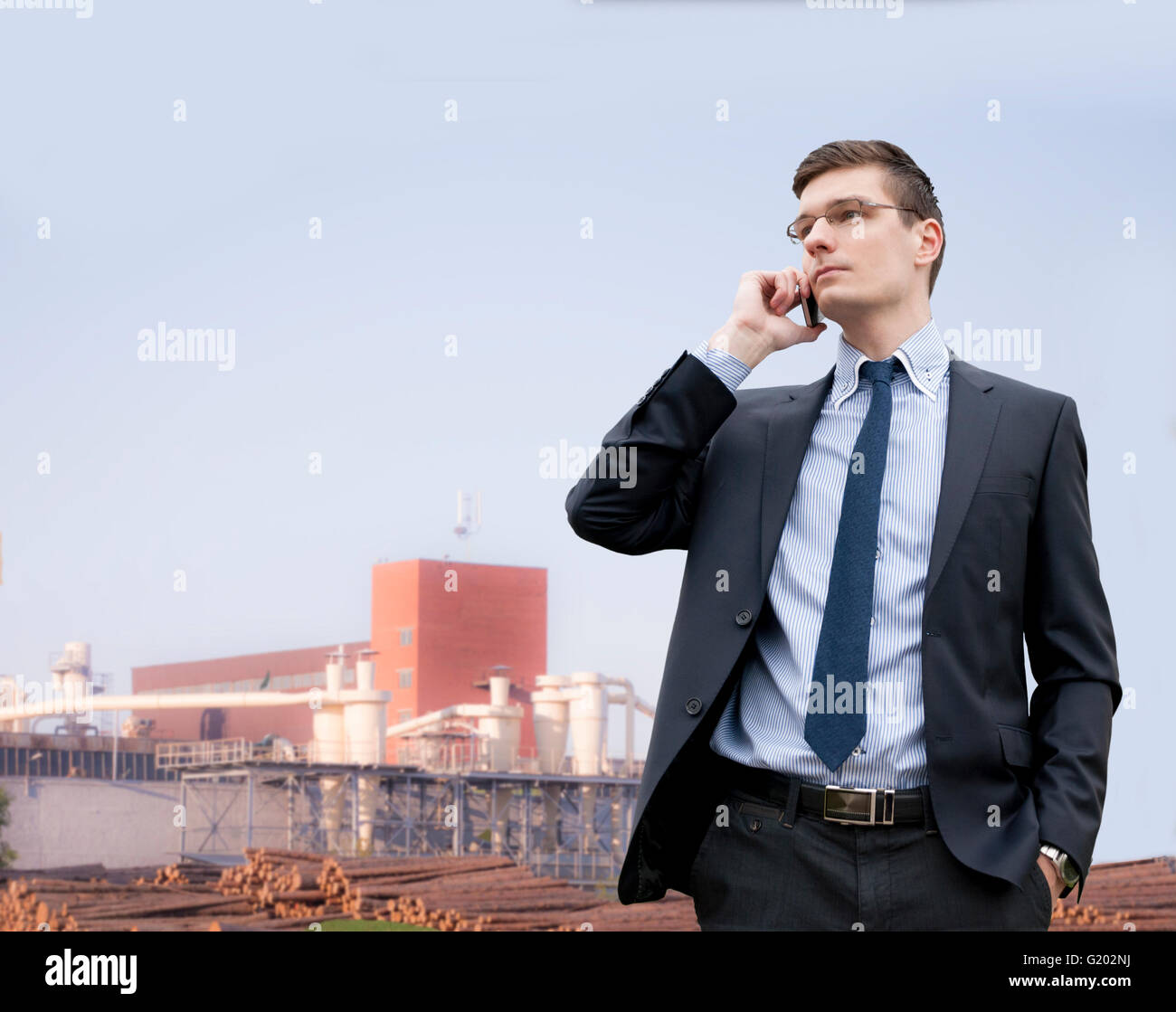 Handsome young businessman on the industrial building background Stock ...