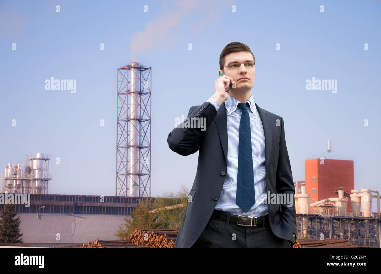 Handsome young businessman on the industrial building background Stock ...