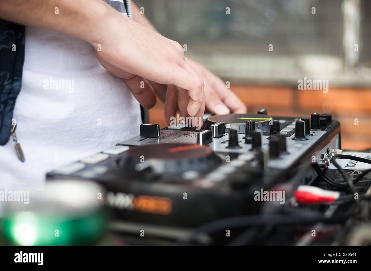 Hands of male Dj playing music on modern midi controller turntable ...