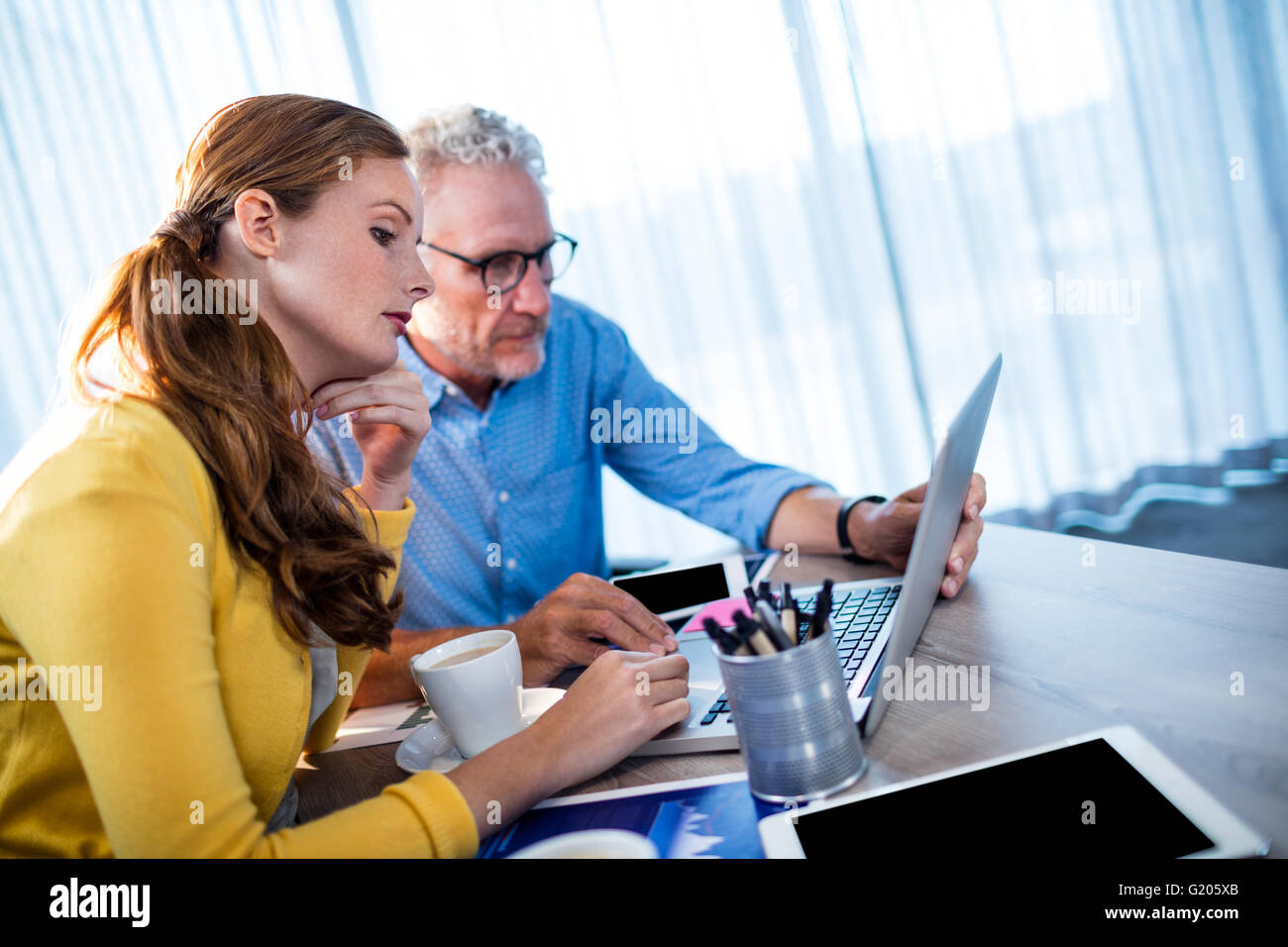 Two businessmen using a computer Stock Photo - Alamy