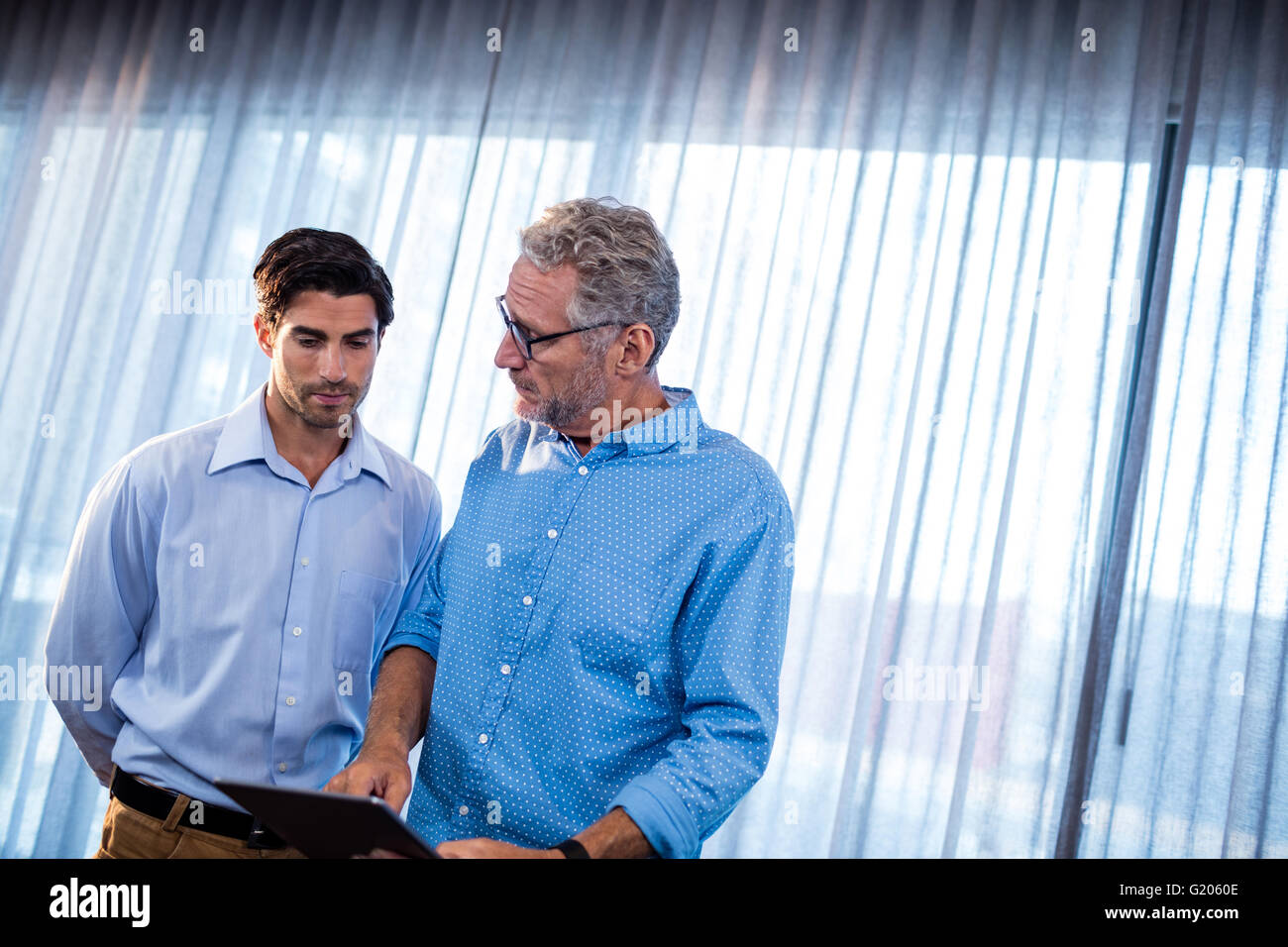 Frowning businessman using tablet hi-res stock photography and images ...