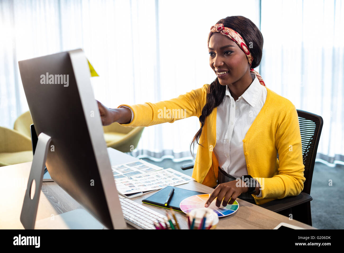 Business woman pointing at her screen Stock Photo - Alamy