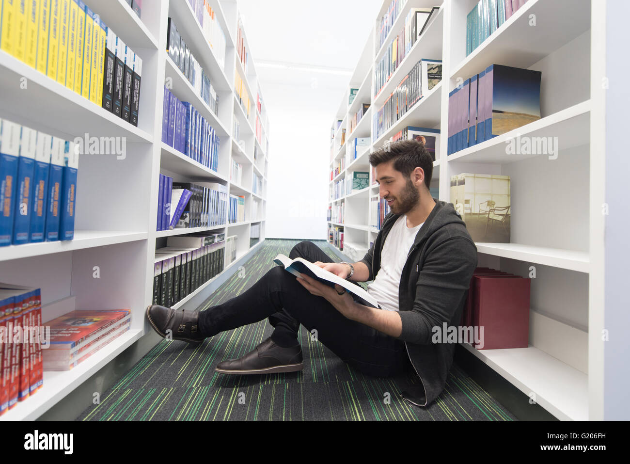 Student reading book in school library. Study lessons for exam. Hard ...