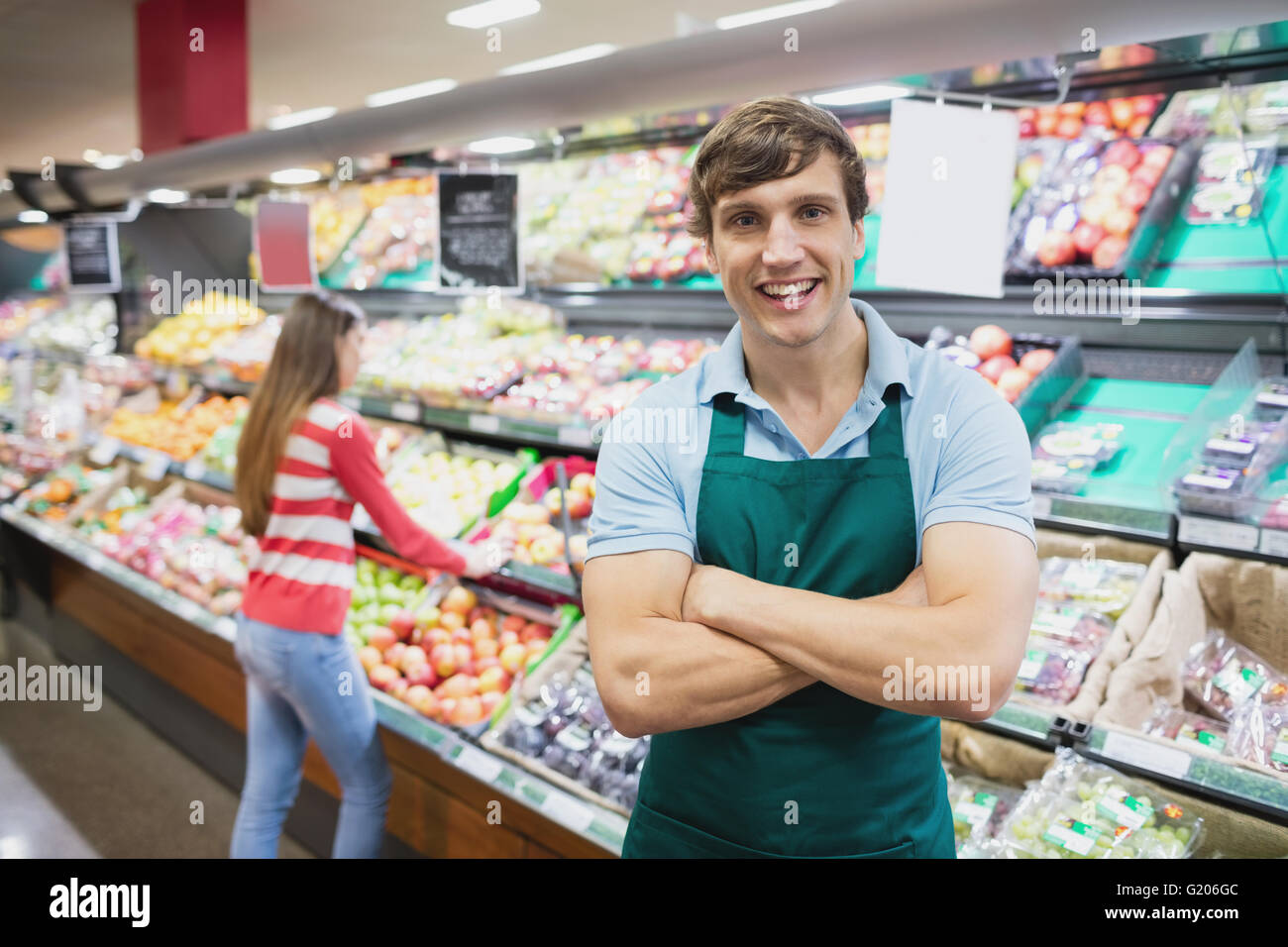 Shop assistant posing with arms crossed Stock Photo - Alamy