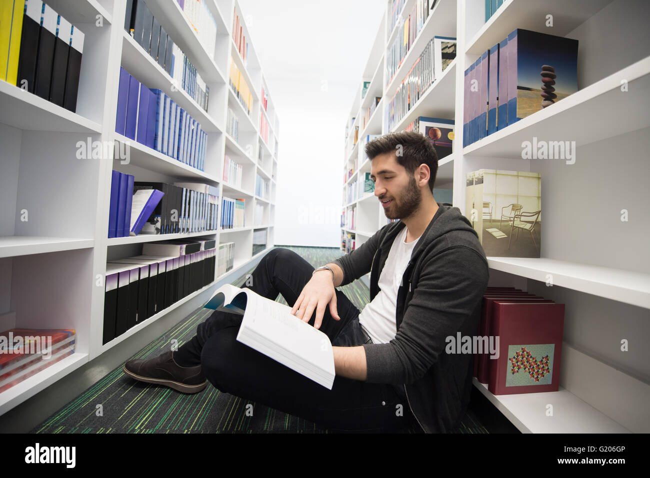 Student reading book in school library. Study lessons for exam. Hard ...