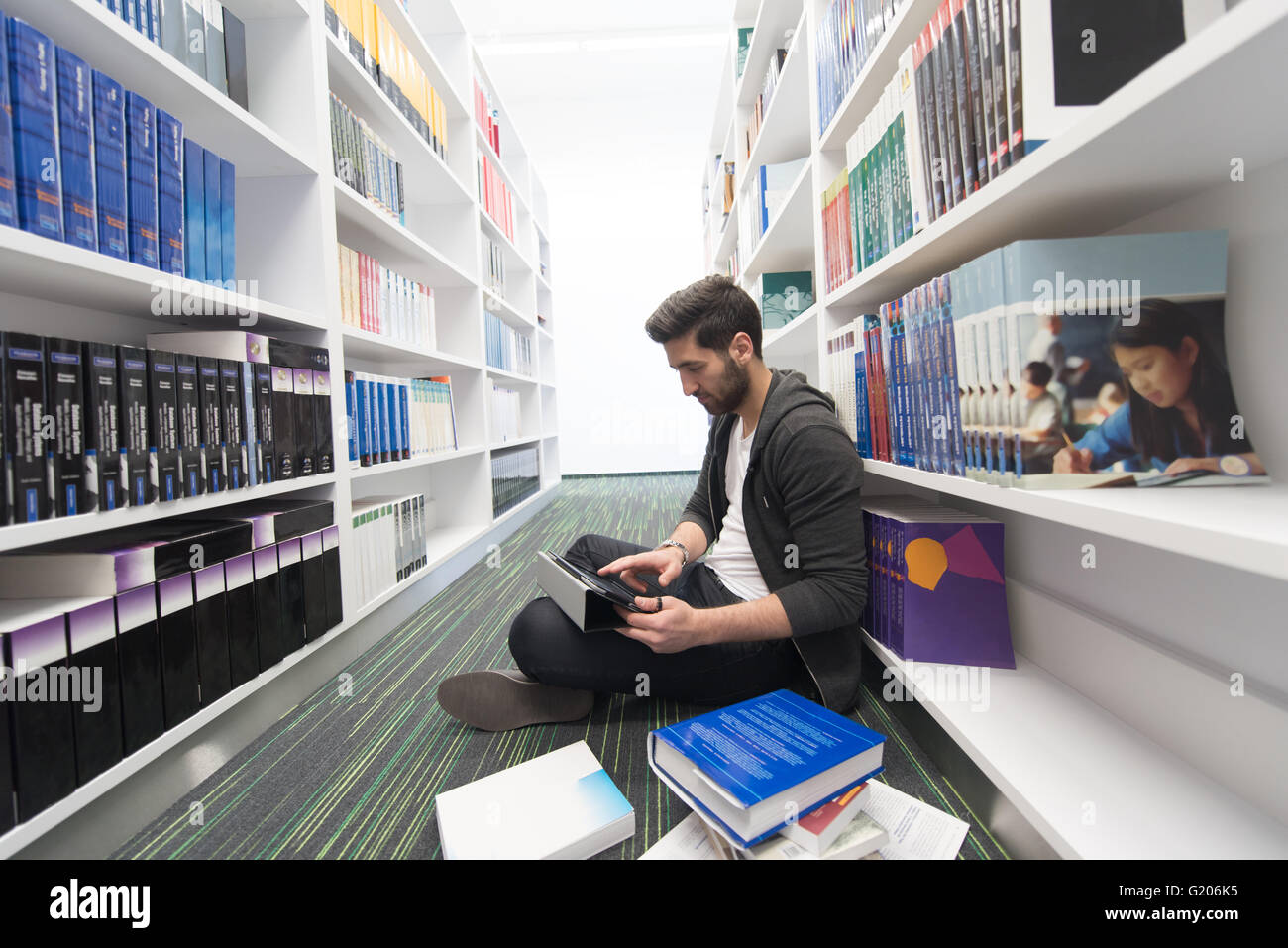 Student reading book in school library. Study lessons for exam. Hard ...
