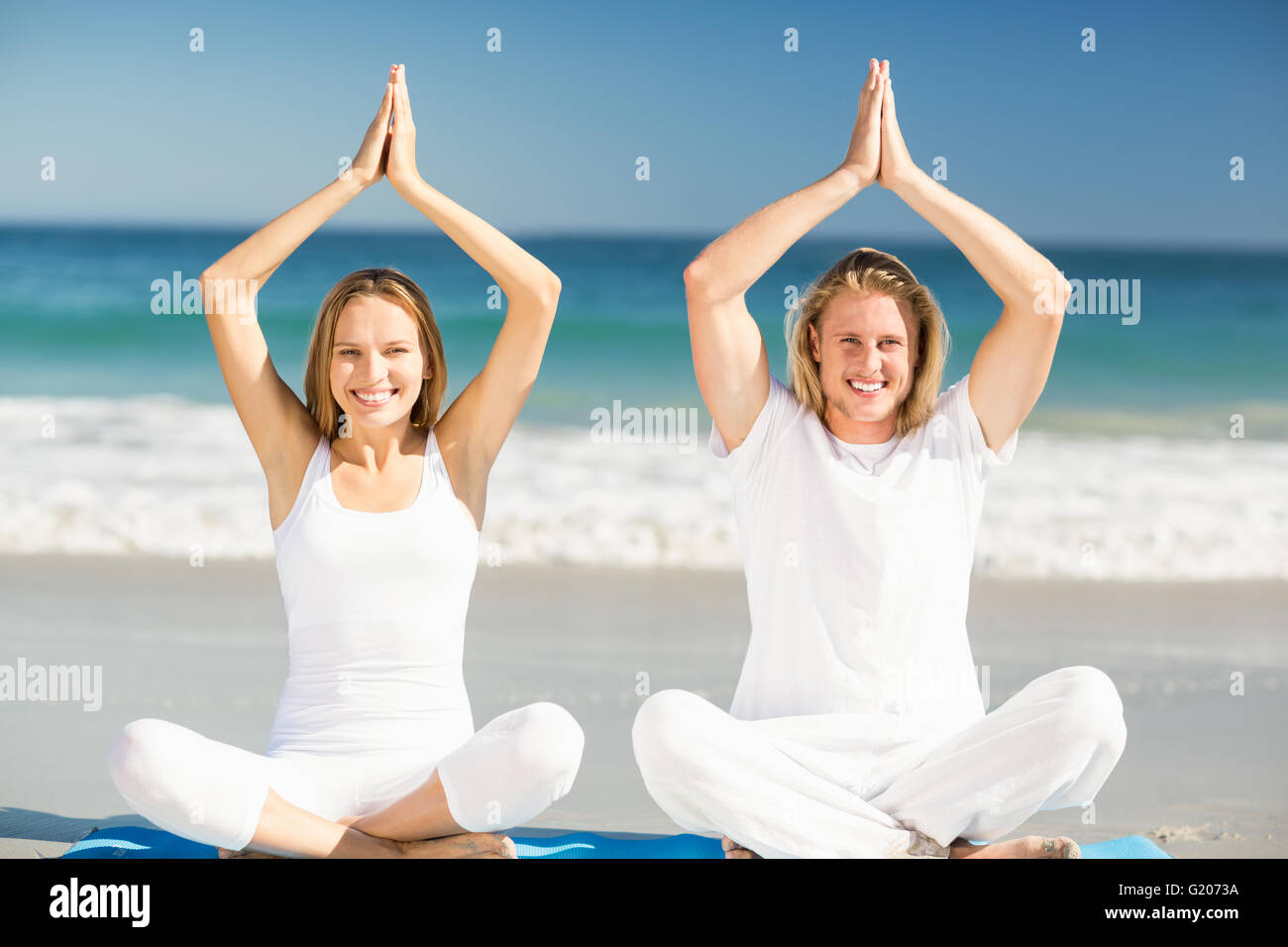 Man and woman performing yoga Stock Photo - Alamy