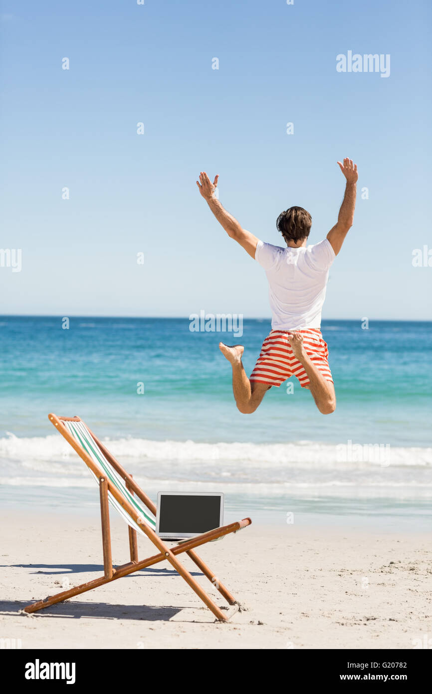 Man jumping on beach Stock Photo - Alamy