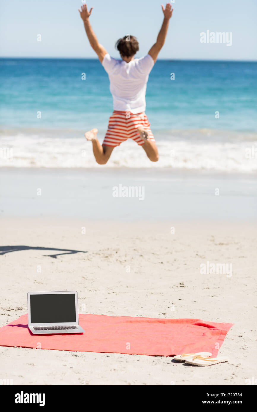 Man jumping on beach Stock Photo - Alamy