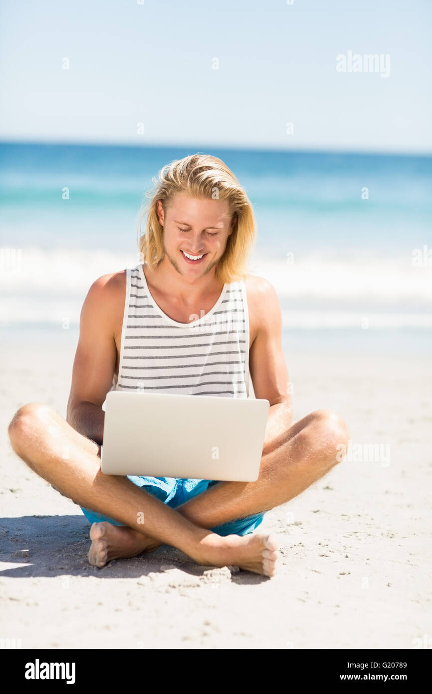 Man using laptop on beach Stock Photo - Alamy