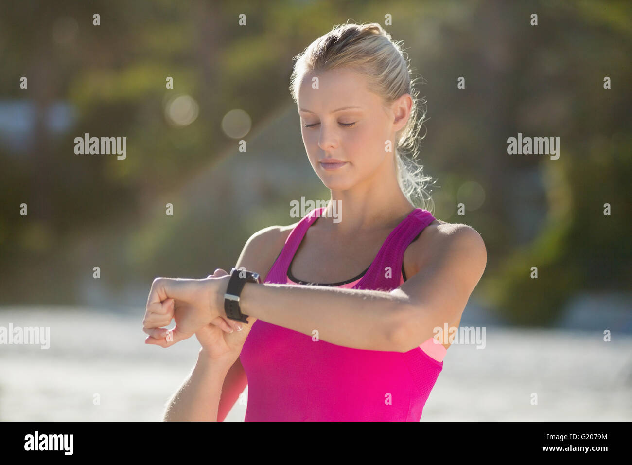 Woman checking time on beach Stock Photo - Alamy