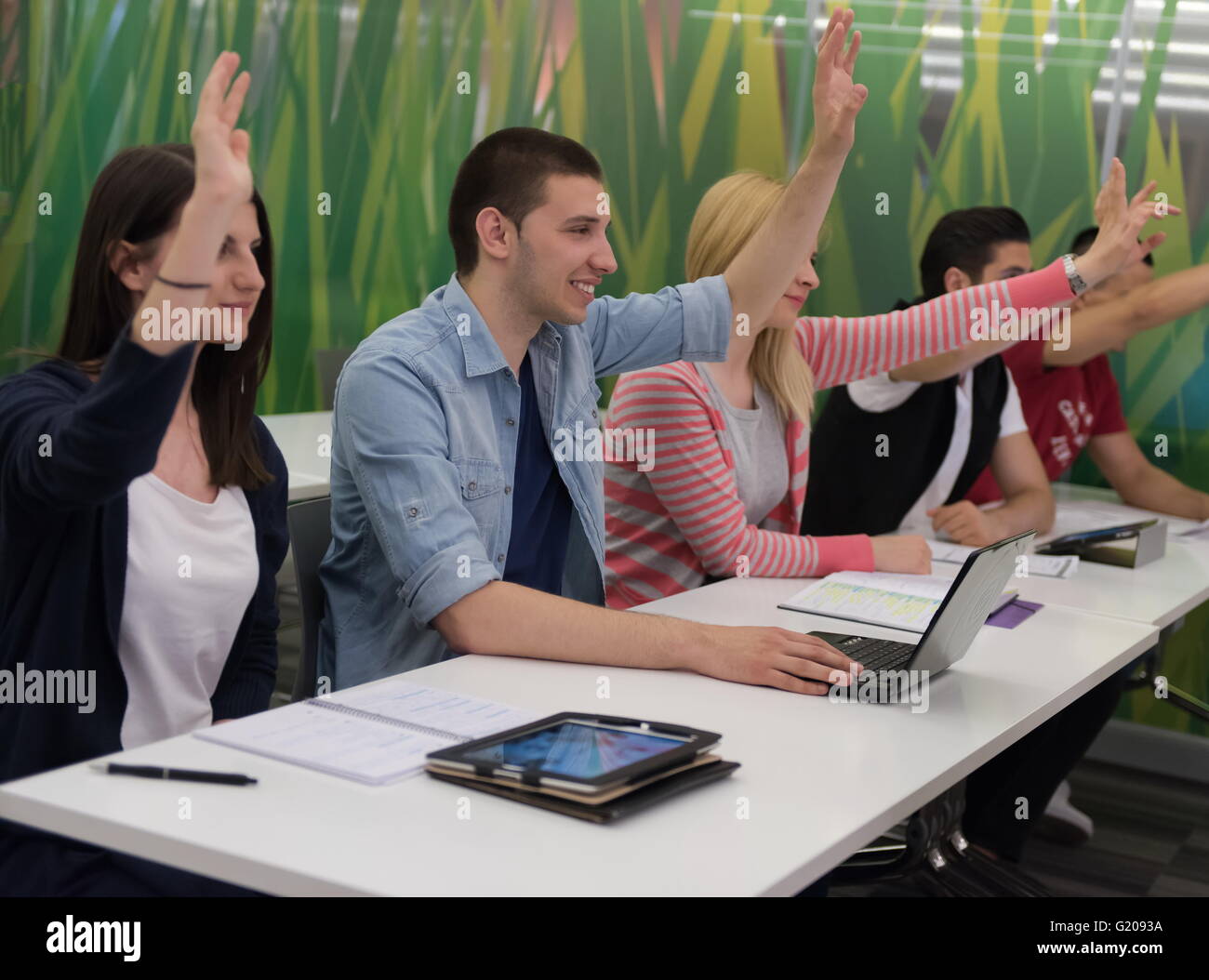 teacher teaching lessons, smart students group raise hands up in school ...