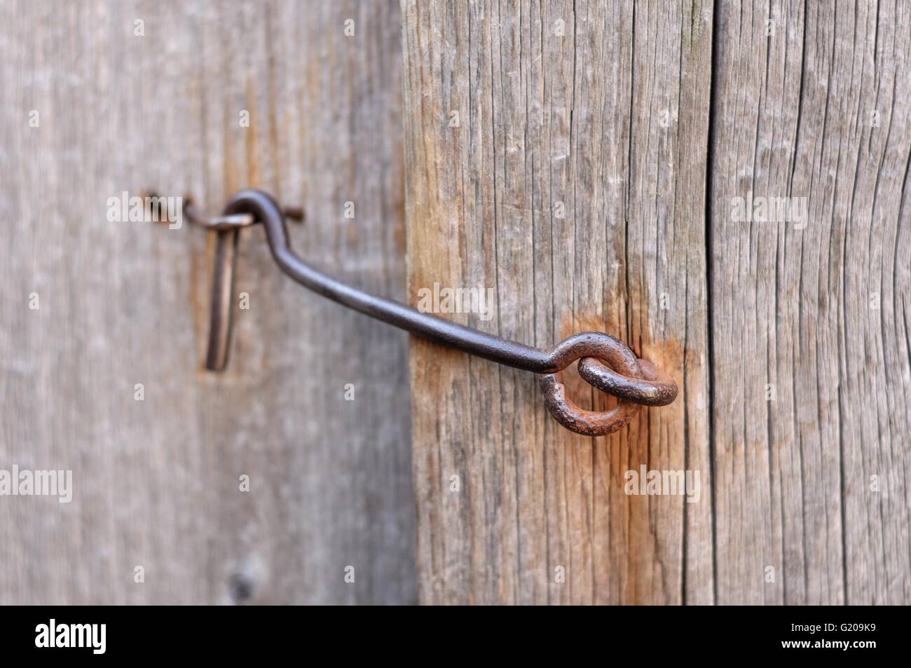 Detail view of old hook on closed door Stock Photo - Alamy