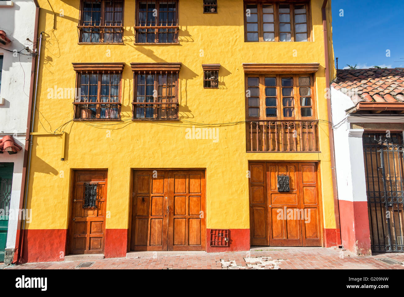 Yellow and red facade of a historic building in La Candelaria ...