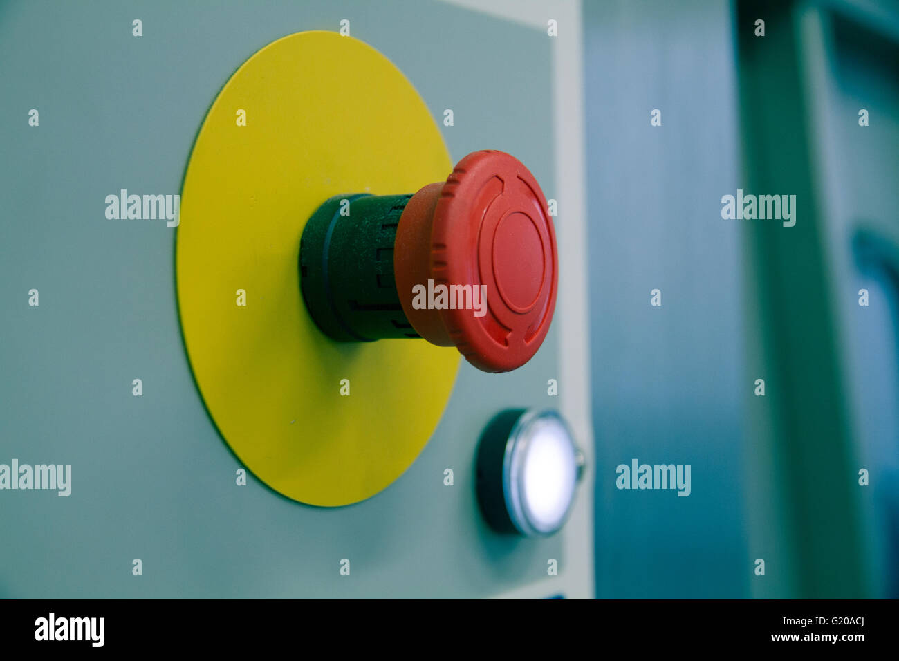 Red button in a factory Stock Photo - Alamy