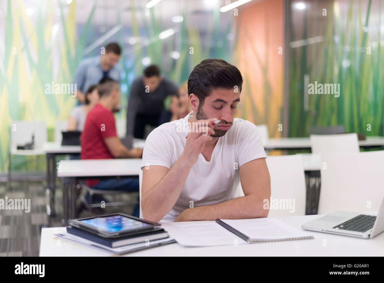 male student in classroom working homework and learning with laptop ...