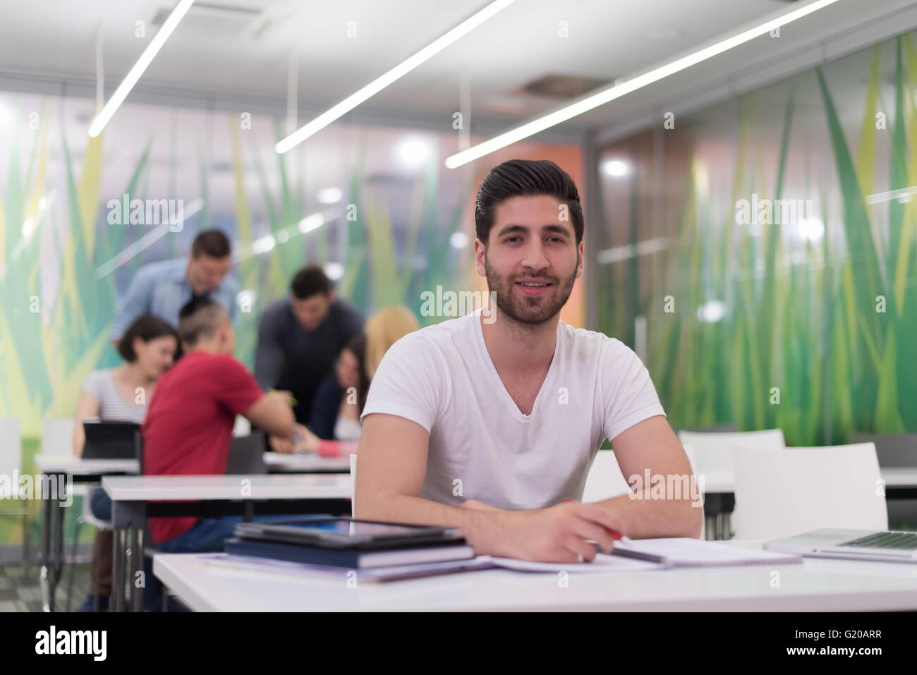 male student in classroom working homework and learning with laptop ...