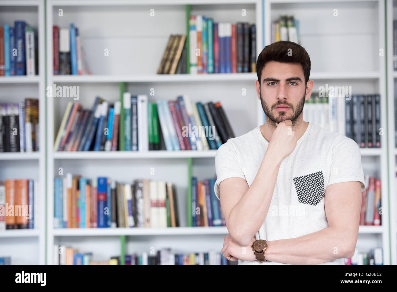 Student reading book in school library. Study lessons for exam. Hard ...