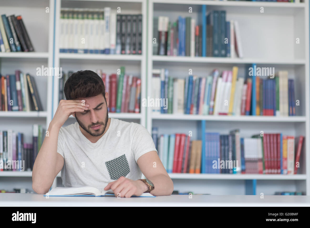 Student reading book in school library. Study lessons for exam. Hard ...