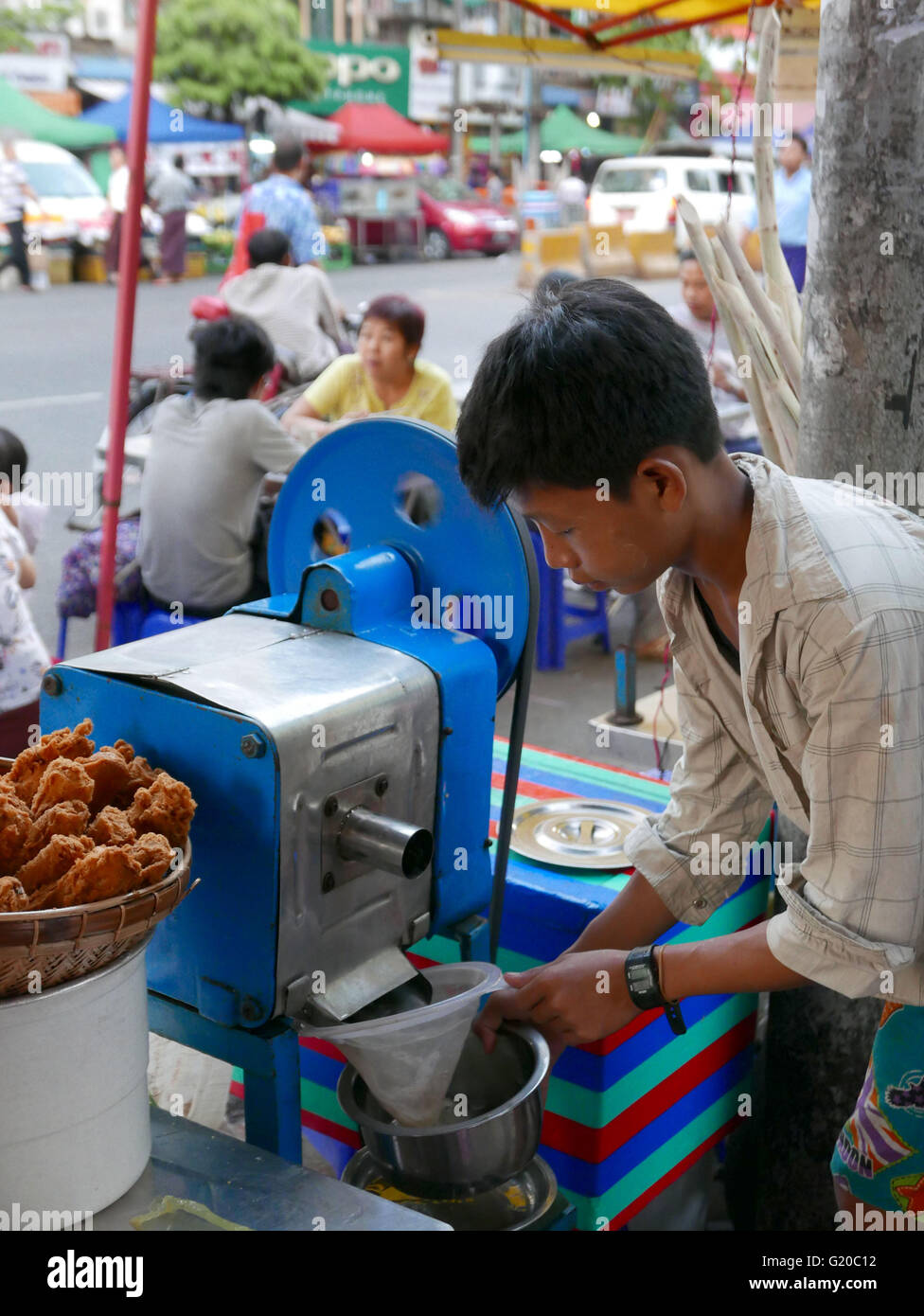 MYANMAR Chinatown street market, man making juice Stock Photo - Alamy