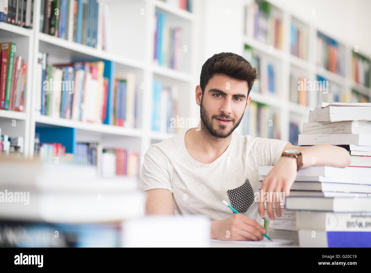 Student reading book in school library. Study lessons for exam. Hard ...