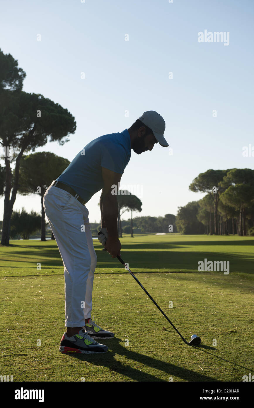 golf player hitting shot with club on course at beautiful morning with ...